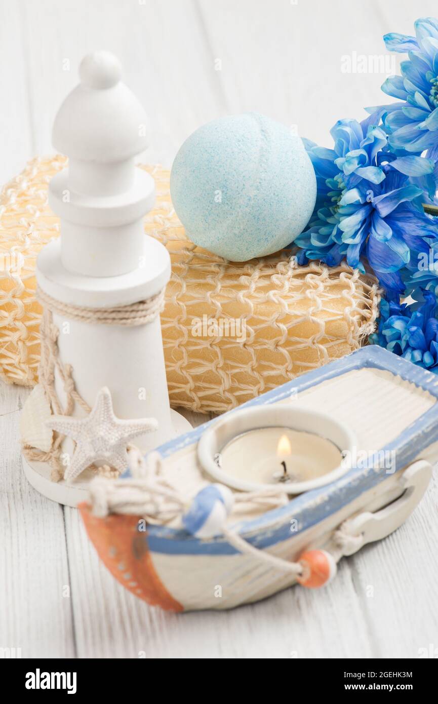 SPA composition with bath bomb, sponge, blue flowers and decorations on ...