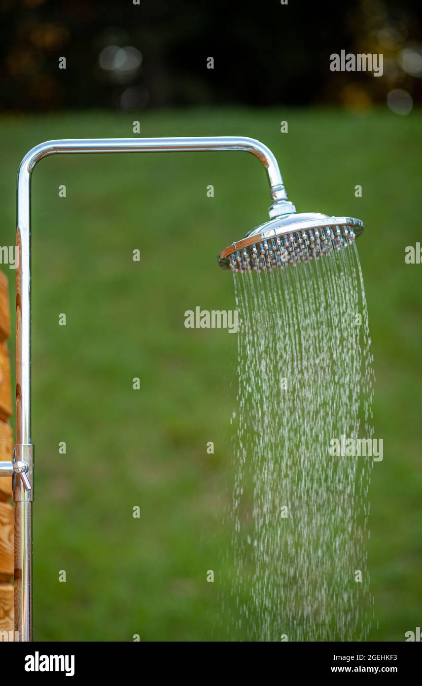 Outdoor shower head stick on the wooden plate pole design for showering ...