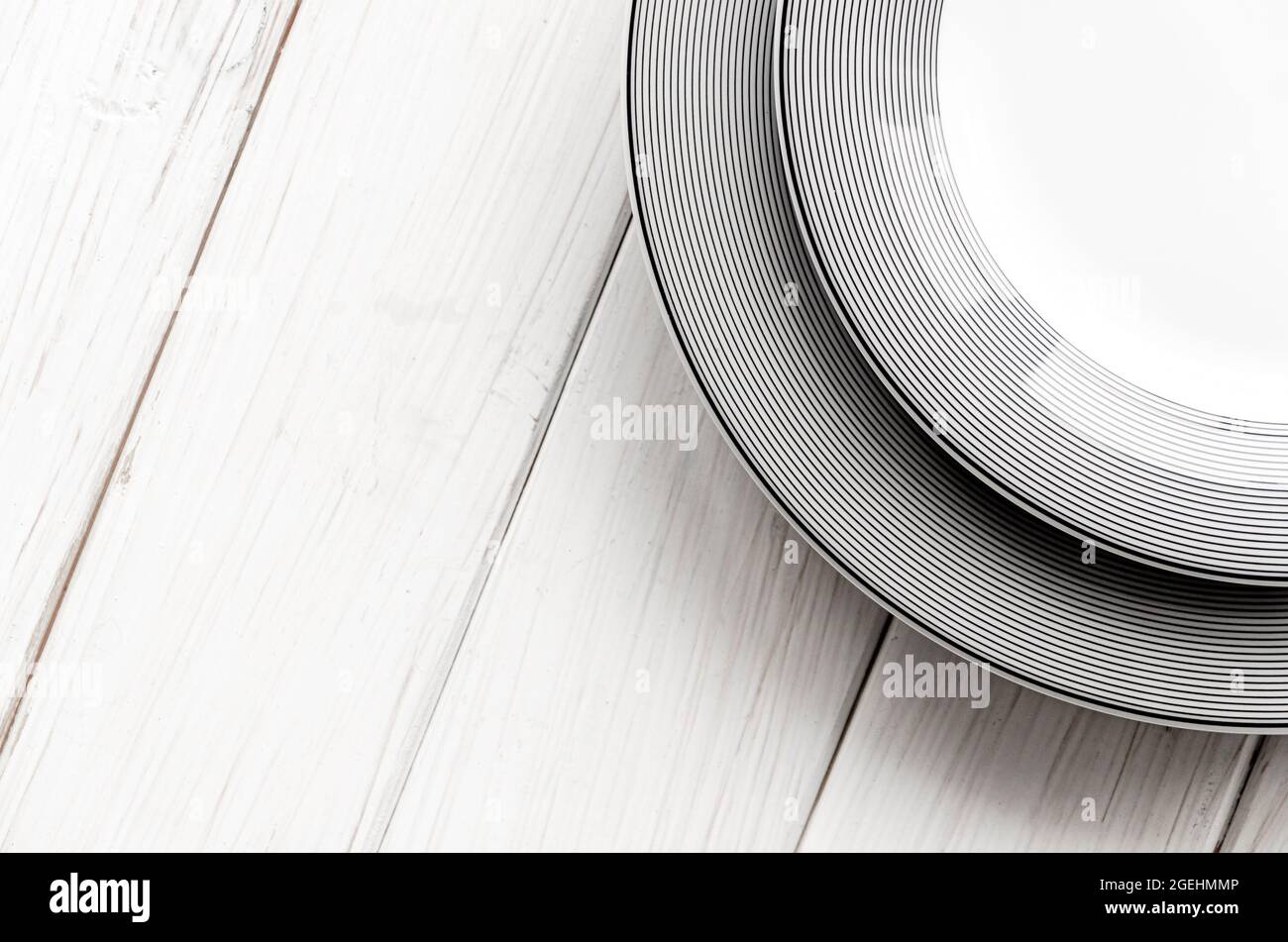 The modern classical porcelain set of plates stands on a white table ...