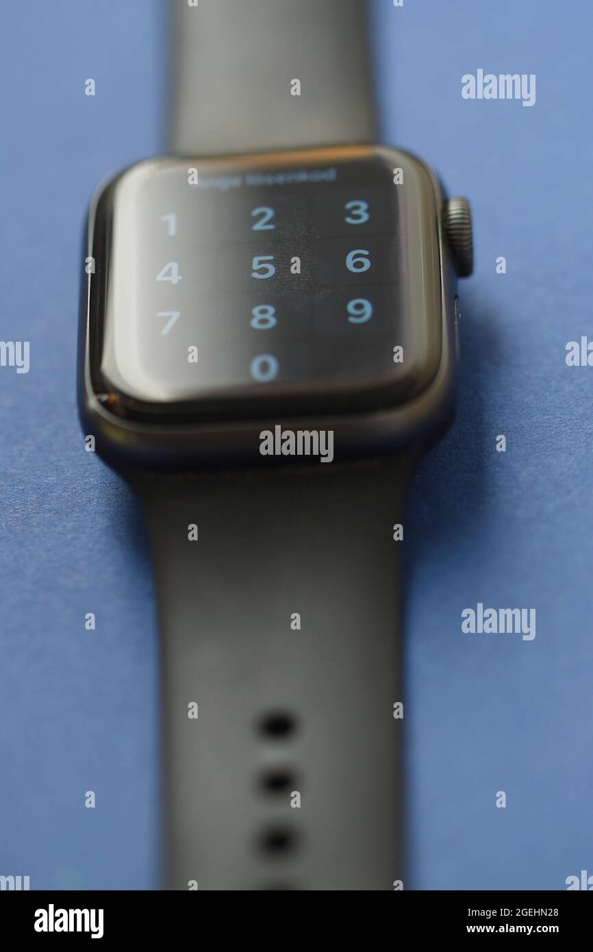 Closeup macro of a modern watch with touch screen on blue background ...