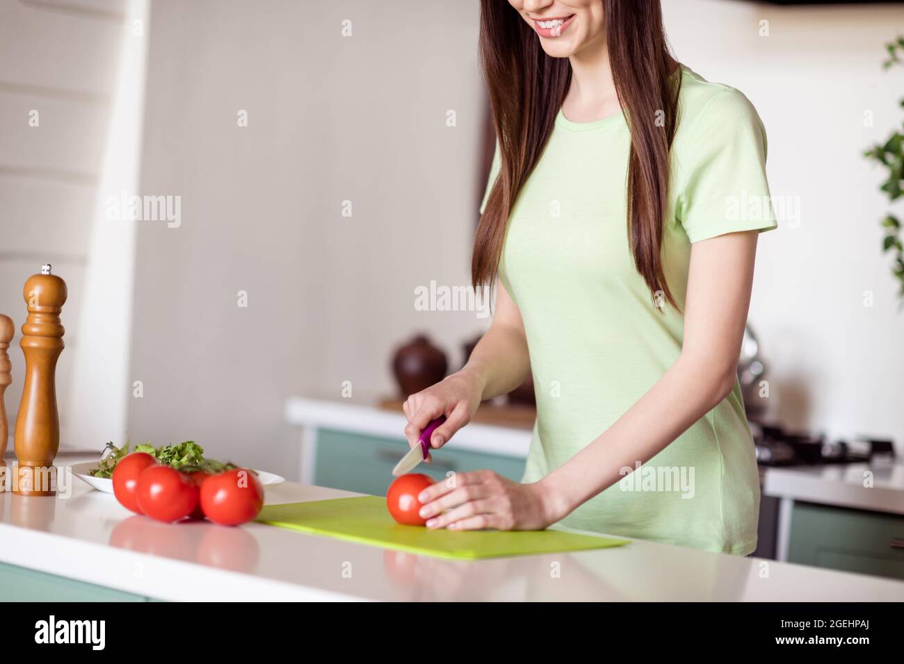Photo of cute adorable young woman dressed green t-shirt cooking ...