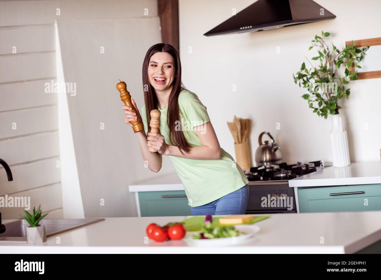 Full length body size photo young woman wearing green t-shirt cooking ...