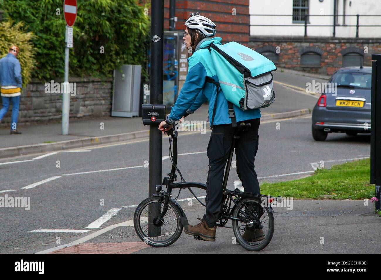 A Deliveroo takeaway bicycle rider with food delivery thermal bag in ...