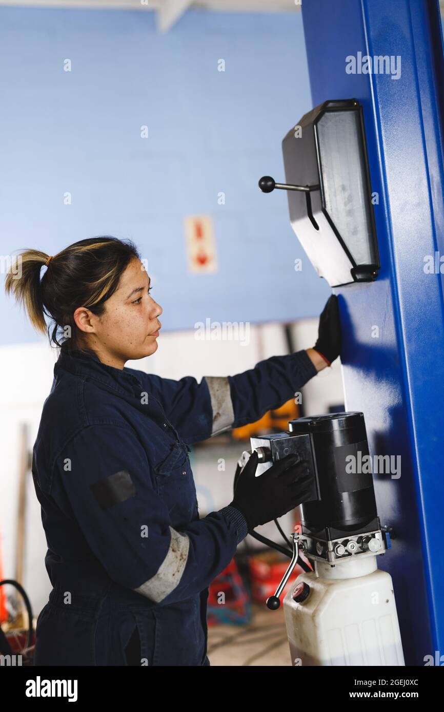 Mixed race female car mechanic wearing overalls, using tools Stock ...