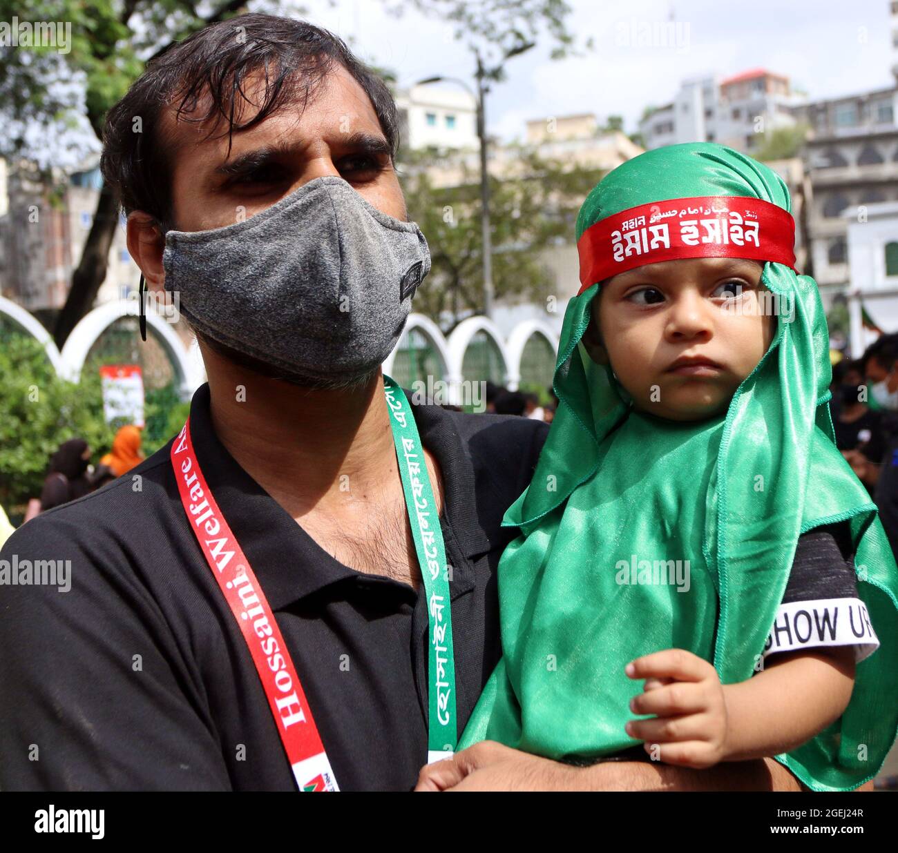 Dhaka, Bangladesh, August 20: A shia man lifts a child on their arms ...