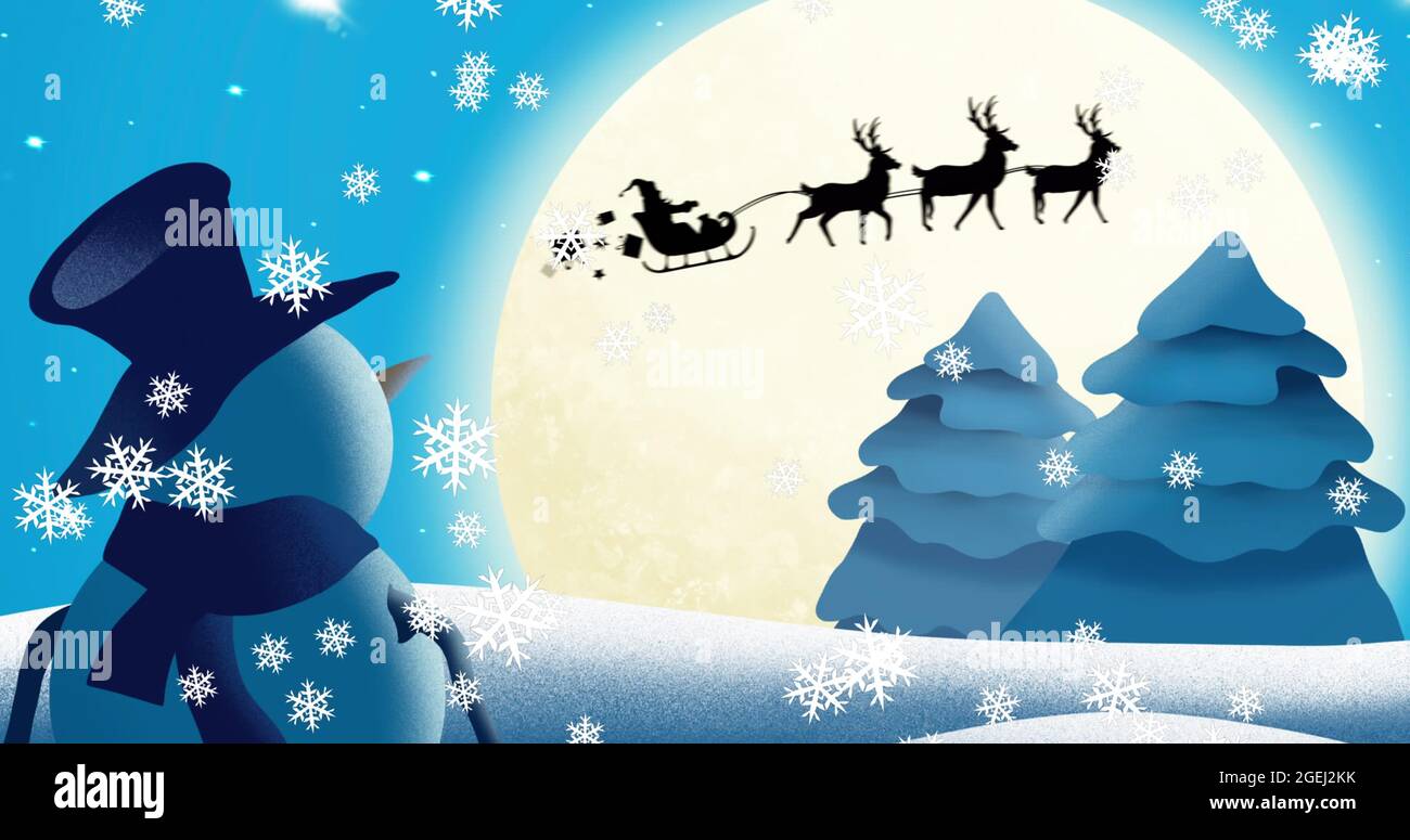 Image of snowman looking at silhouette of santa claus in sleigh being ...
