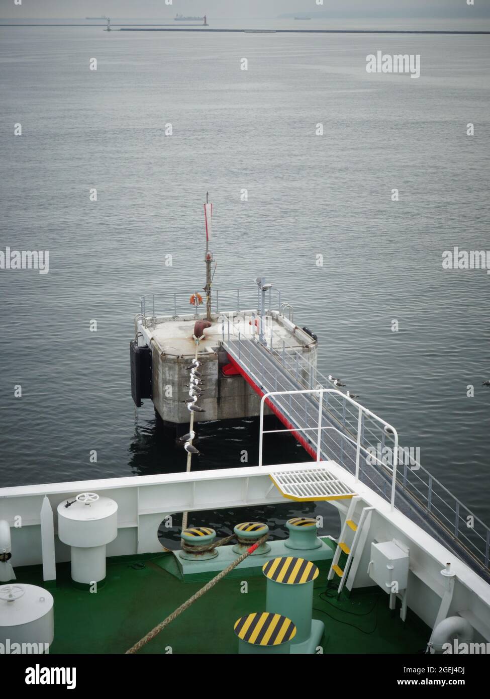 Cruise ship anchor attached to concrete harbour dock pile with seagulls ...