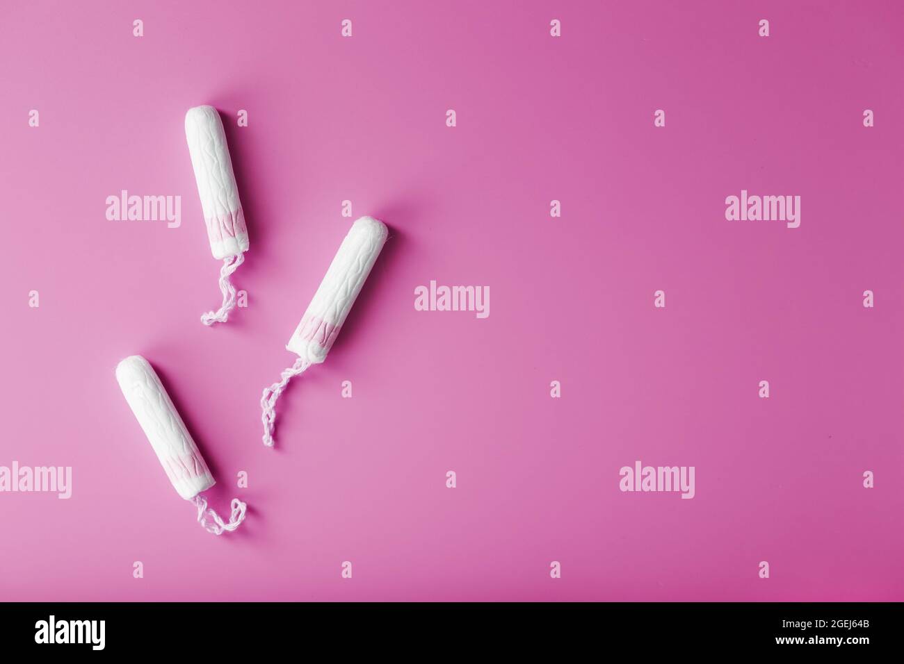 Cotton tampons on a pink background with a free space. Top view, flat ...