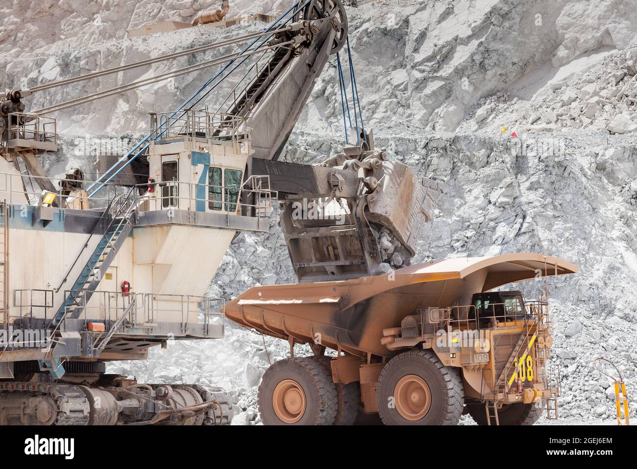 Electric rope shovel loading a dump truck at a copper mine in Peru ...
