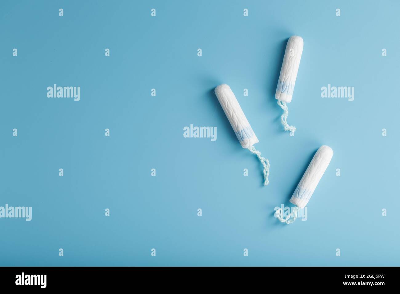 Cotton tampons on a blue background with a free space. Top view, flat ...