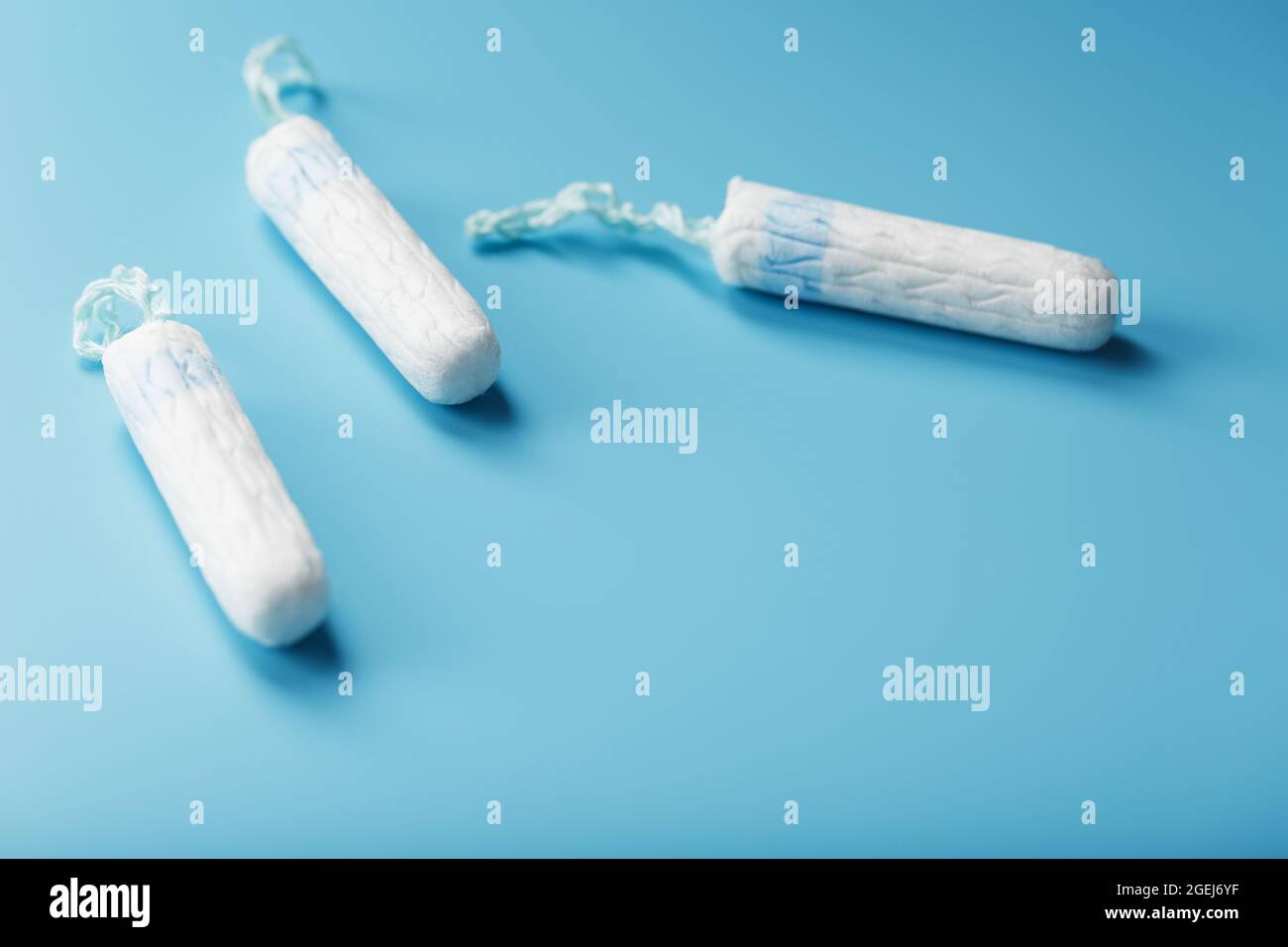 Cotton tampons on a blue background with a free space. Top view, flat ...