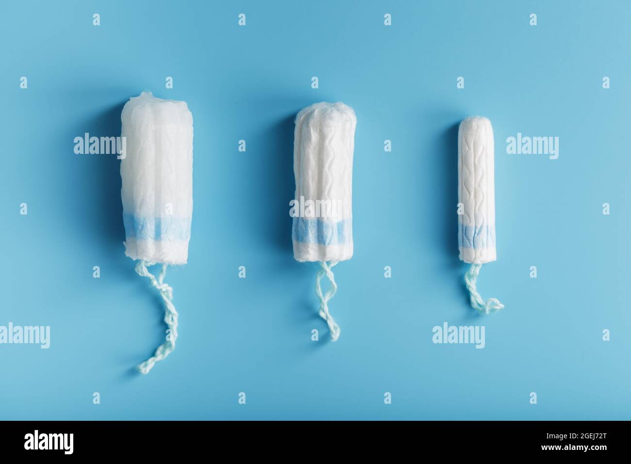 Cotton tampons on a blue background with a free space. Top view, flat ...