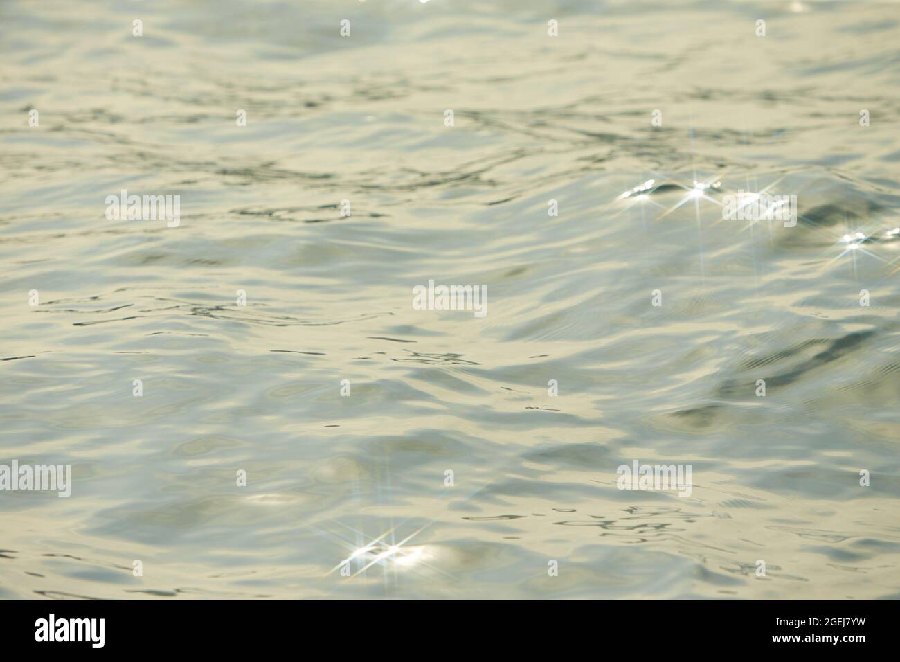 Detail of a sunlight reflecting in glittering sea. sparkler in water ...