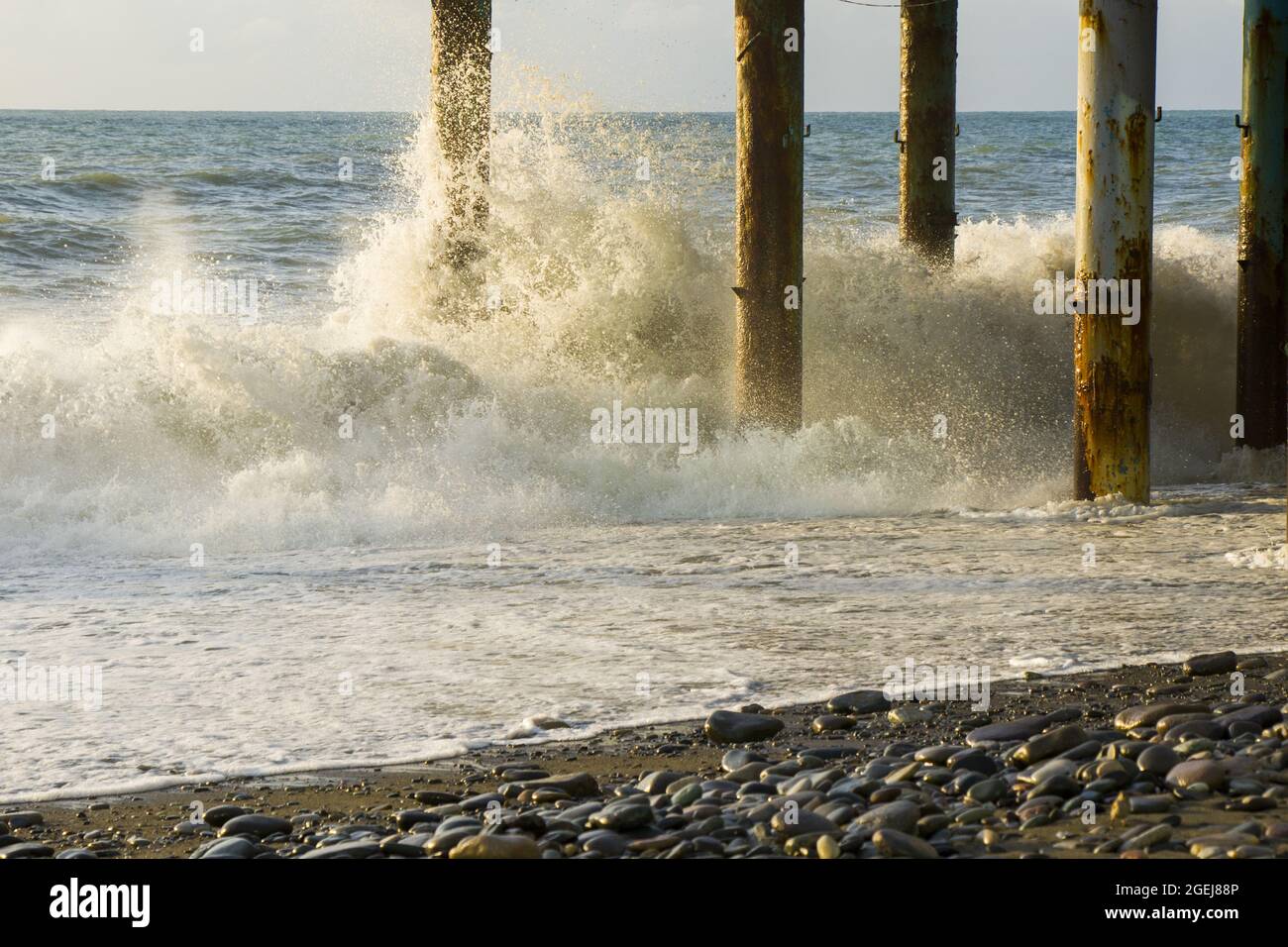 Big sea waves and splashes hitting metal posts during stormy weather in Batumi, Georgia Stock ...