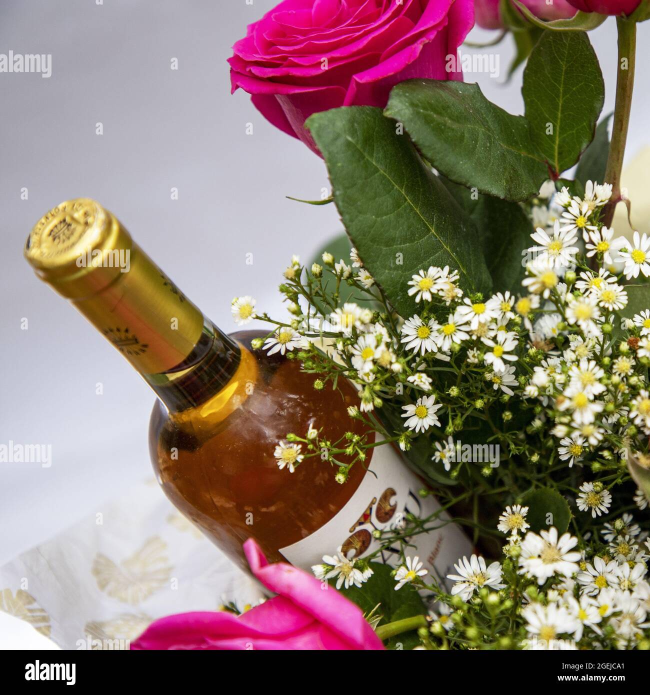 Vertical shot of a beautiful bouquet with a bottle of wine Stock Photo ...