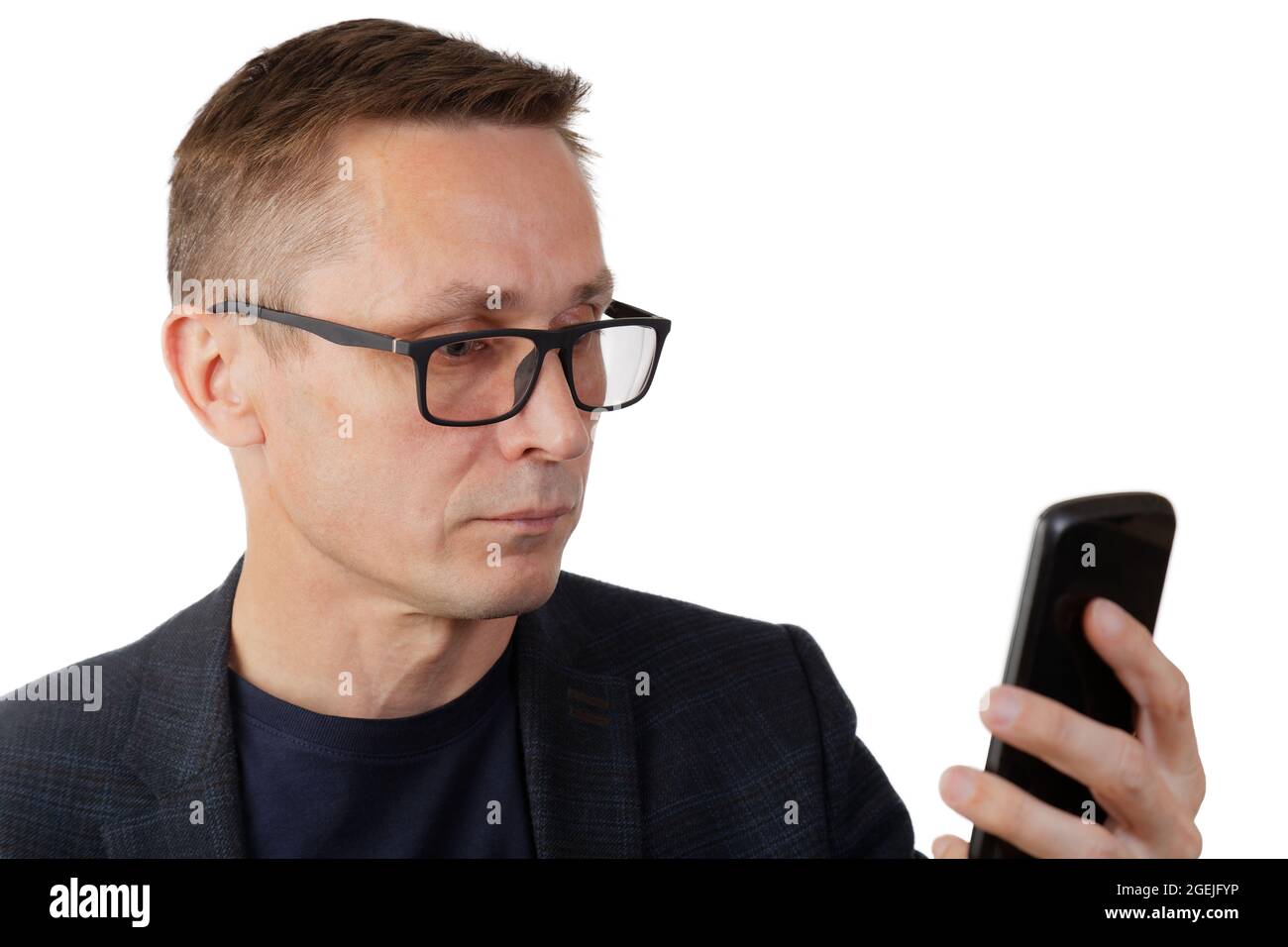 Closeup portrait of a man who looks at the screen of the smartphone ...