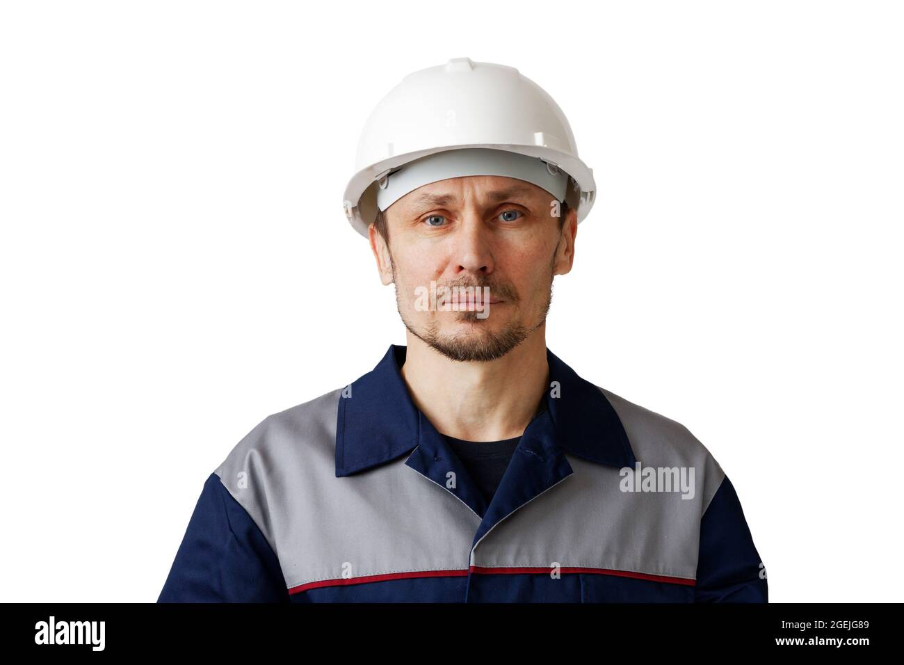 Portrait of a man in a white construction helmet and work clothes ...