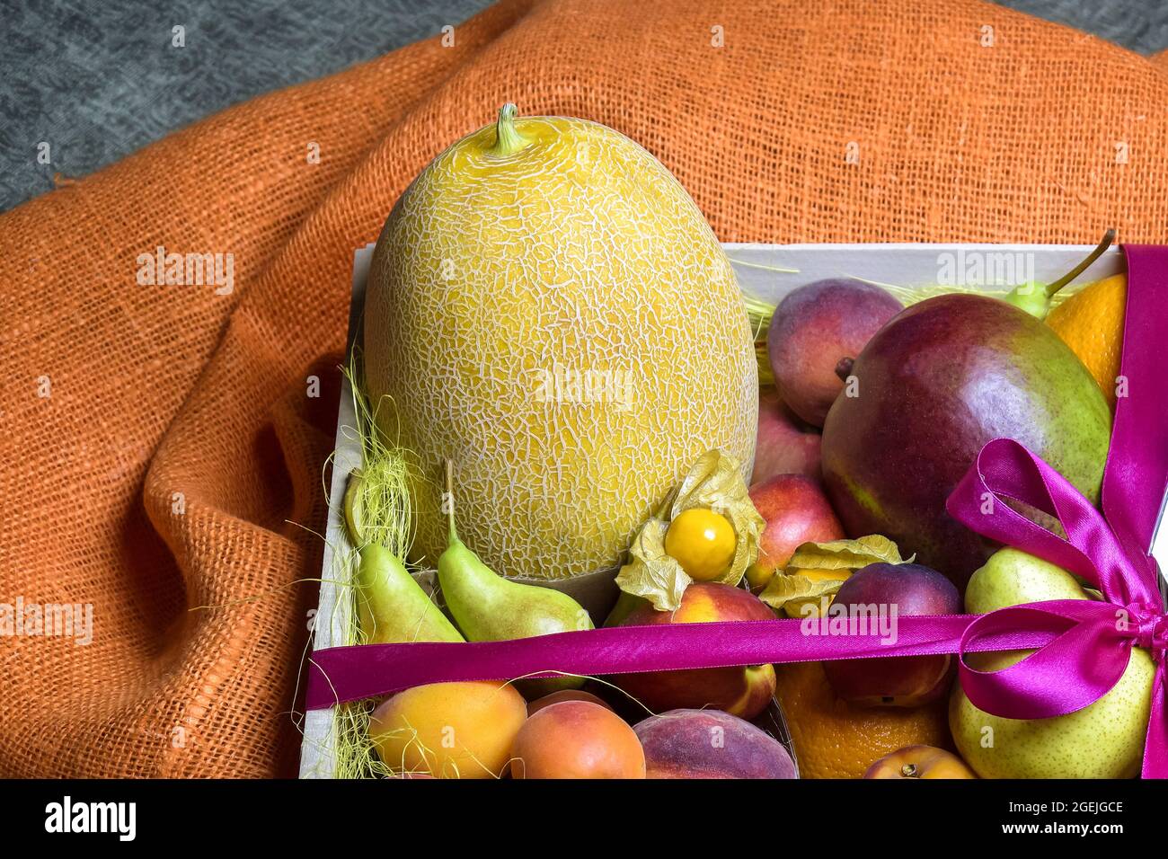 Juicy ripe fruits and berries are beautifully stacked in wooden box ...
