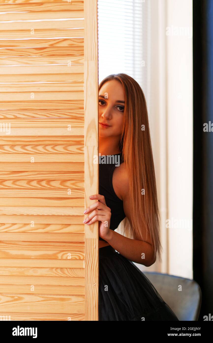 Girl from behind screen hi-res stock photography and images - Alamy
