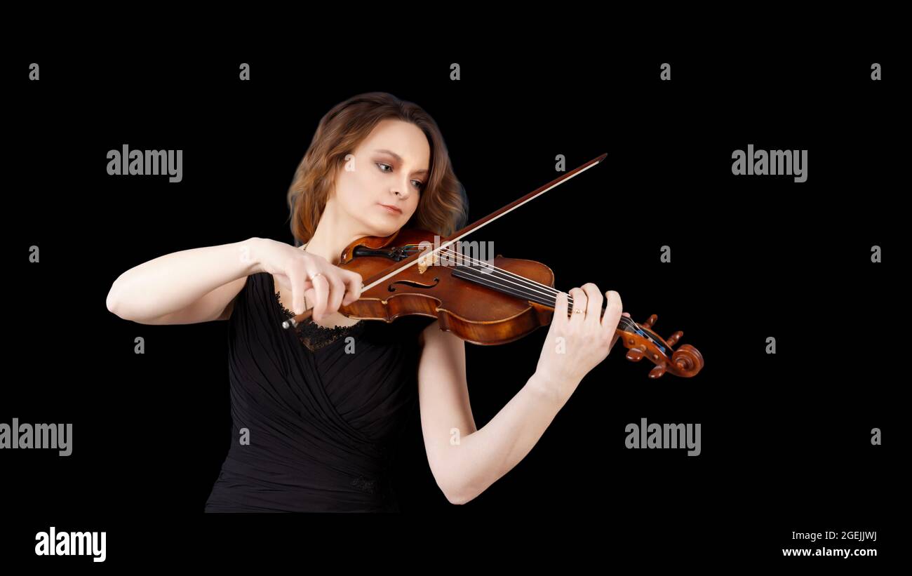 Young woman playing the violin. Isolated on black background. Copyspace ...