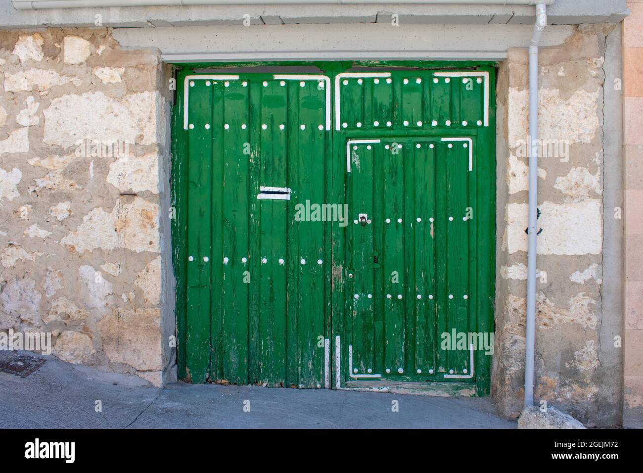 Closeup of old green-painted wooden gates on the stone wall Stock Photo ...
