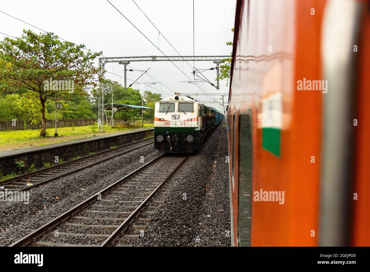 Freight train crossing at Kudal Railway Station during Monsoon season ... Freight train crossing at Kudal Railway Station during Monsoon season ...