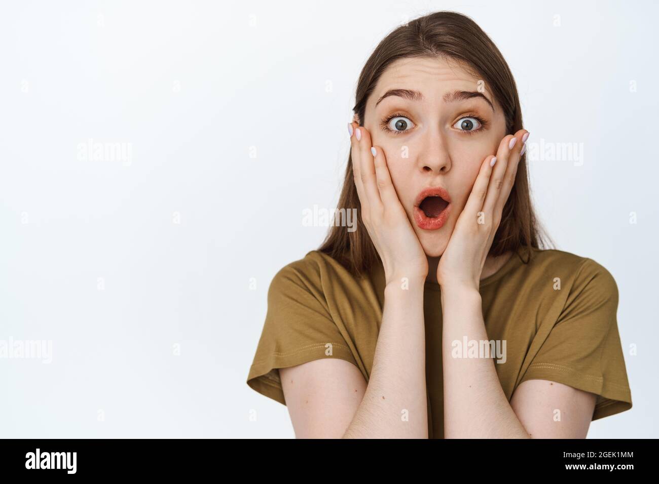 Close up portrait of impressed girl staring in awe, saying wow, looking ...