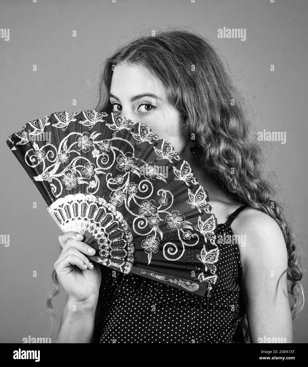 Summer heat. Fresh air. Kid girl fanning herself with fan. Air ...