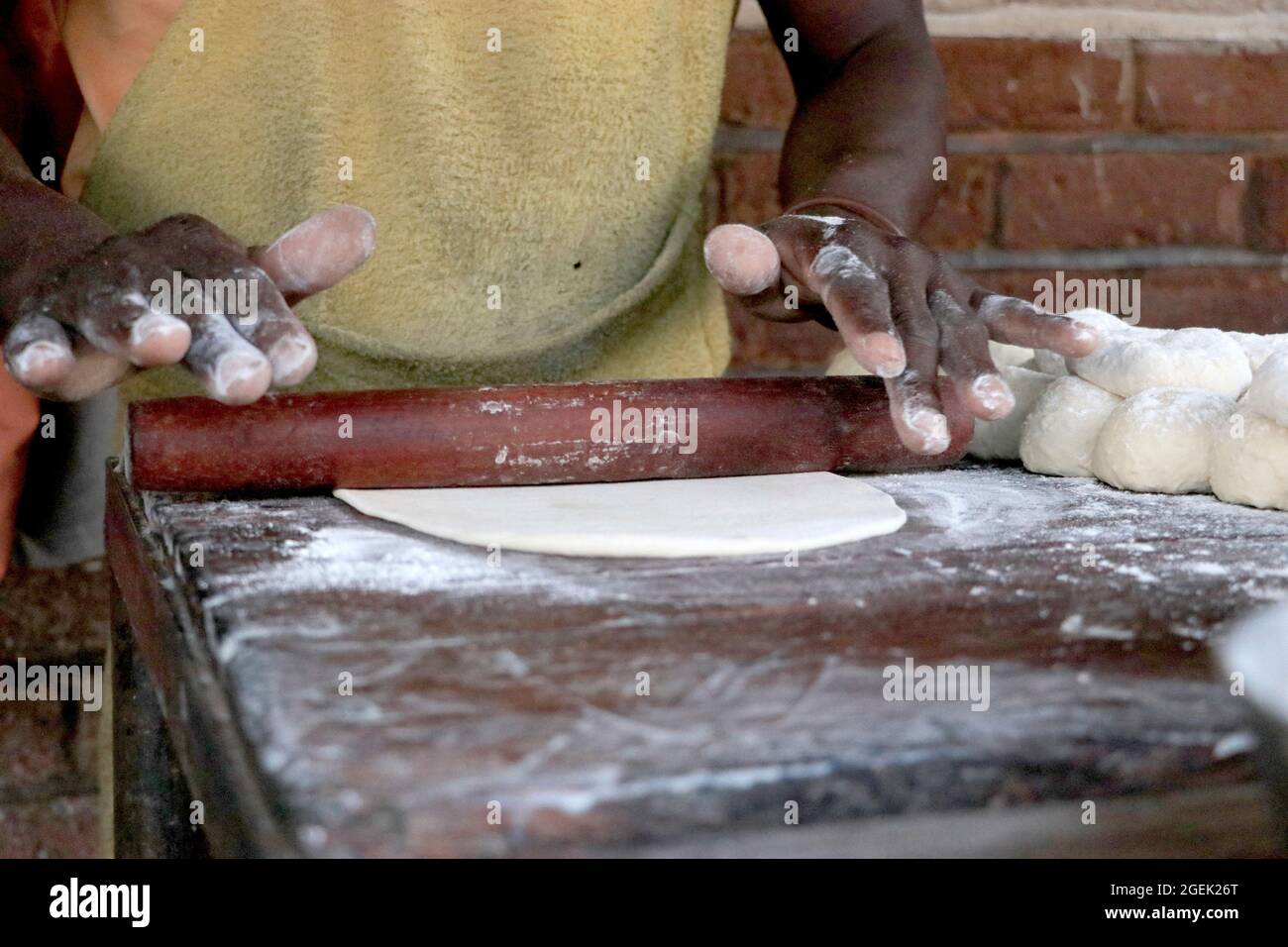A man makes 'chapati' an Indian type bread in Dzaleka Refugee Camp ...