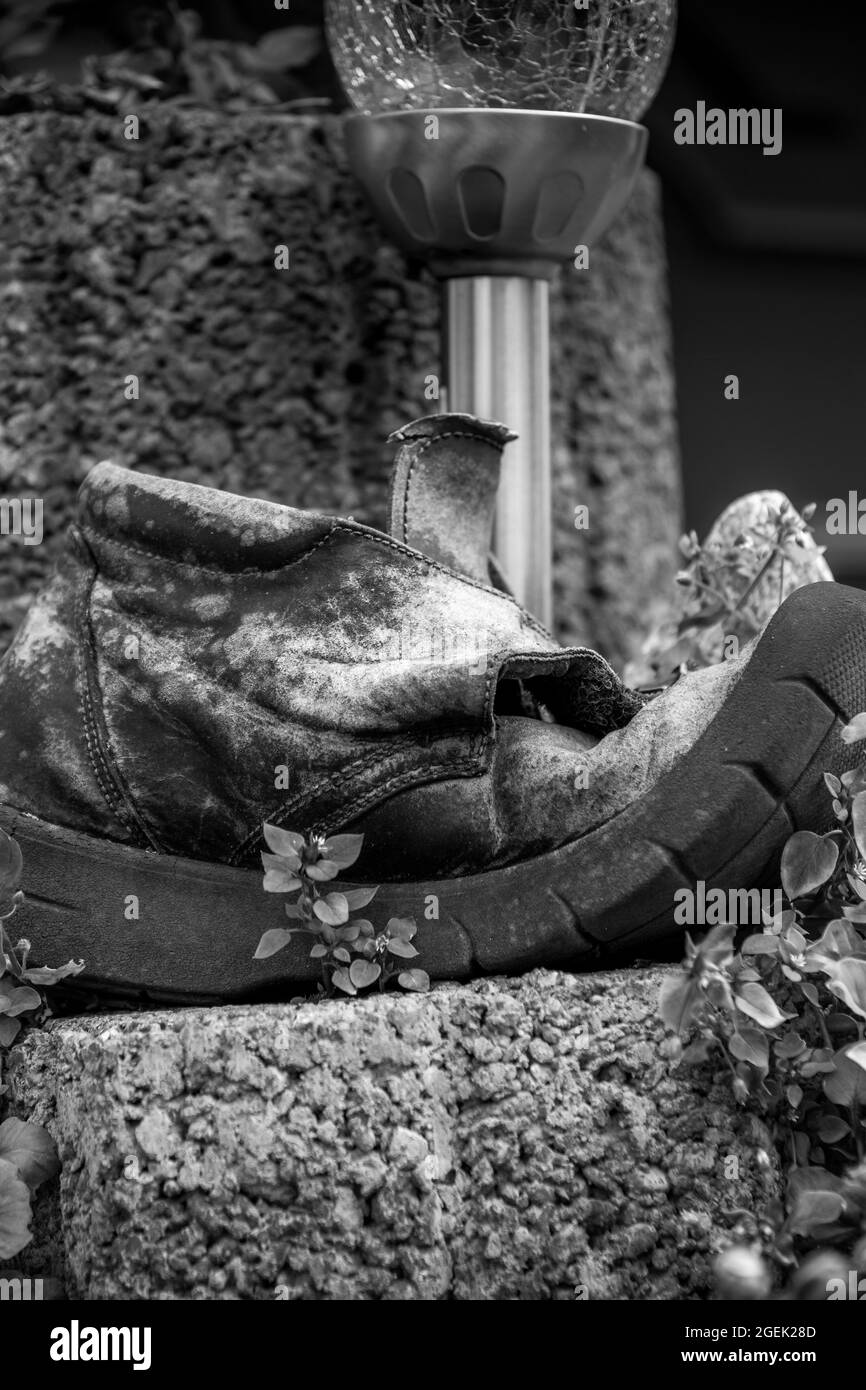 Grayscale shot of an old shoe in the porch Stock Photo - Alamy