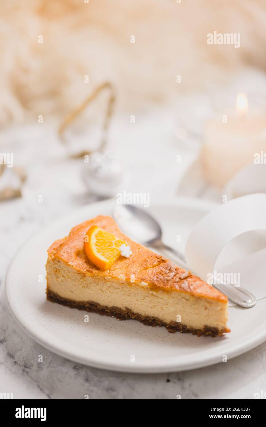 Festive orange cheesecake slice. Serving of traditional Polish ...