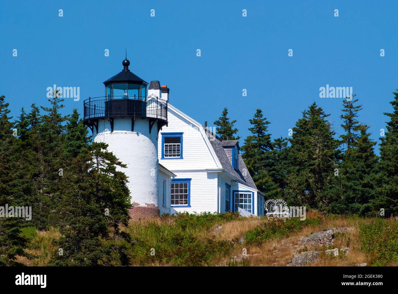 Bear Island lighthouse on an island hilltop, surrounded by evergreen ...