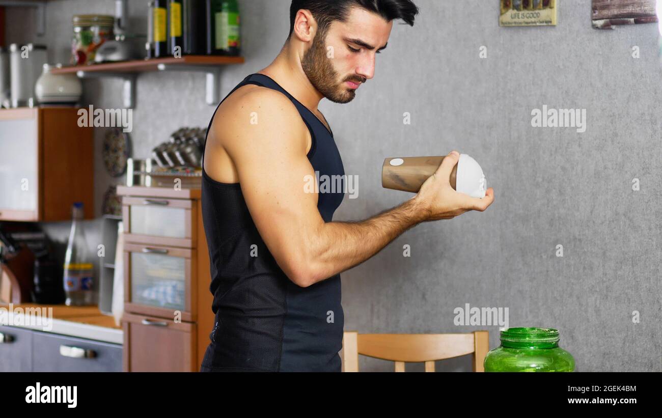 Young man drinking a smoothie drink or a protein shake Stock Photo - Alamy