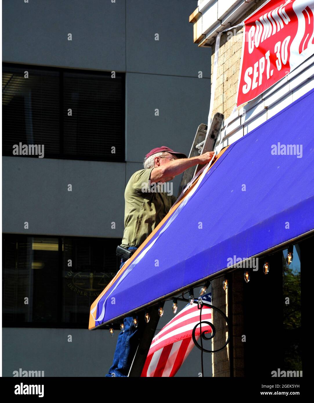 Man ladder hanging banner hi-res stock photography and images - Alamy