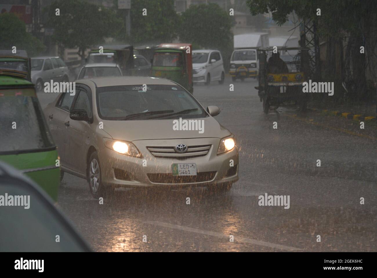 Lahore, Pakistan. 20th Aug, 2021. Pakistani motorists are on their way during heavy monsoon rain ...