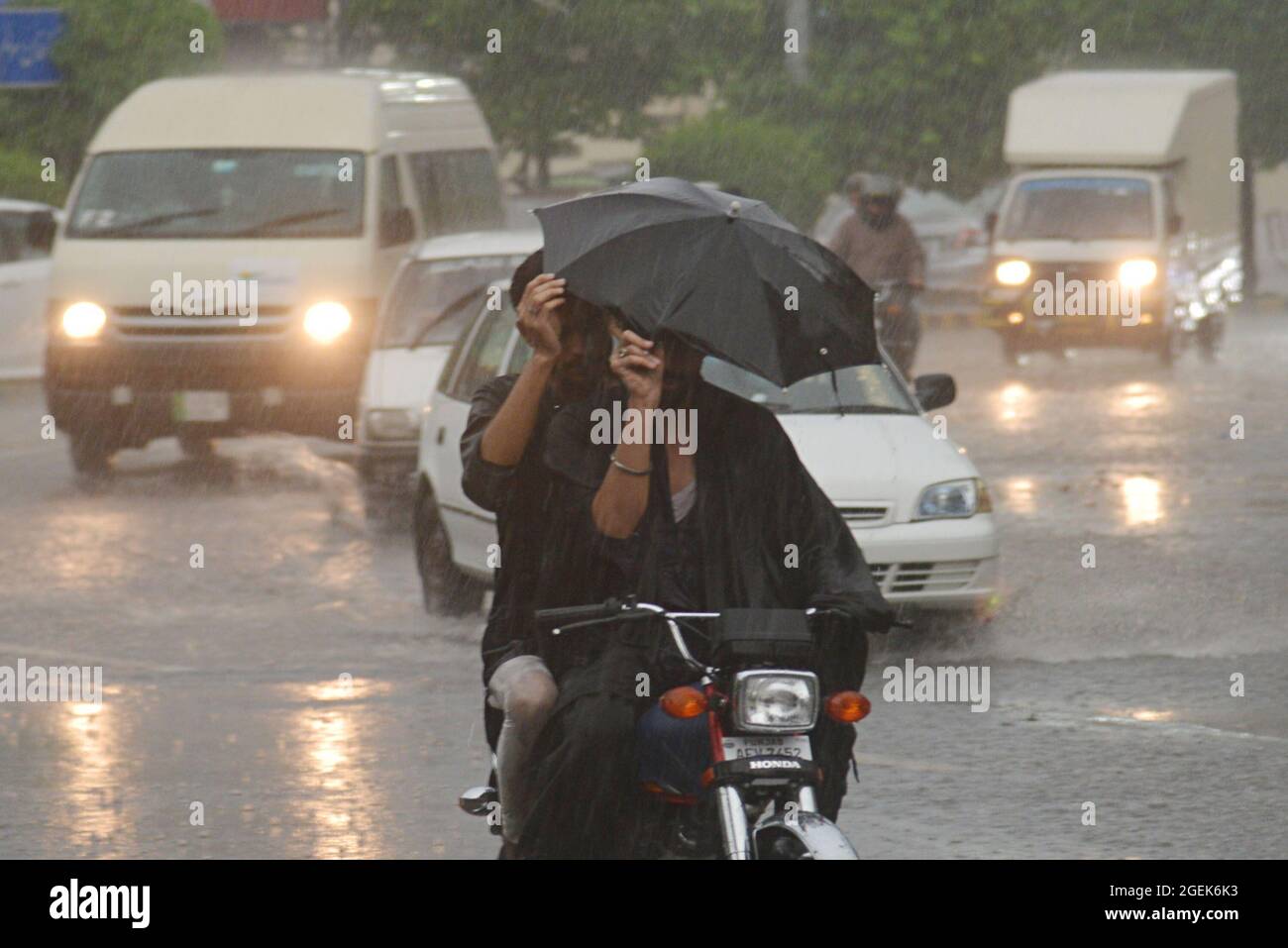 Lahore, Pakistan. 20th Aug, 2021. Pakistani motorists are on their way during heavy monsoon rain ...