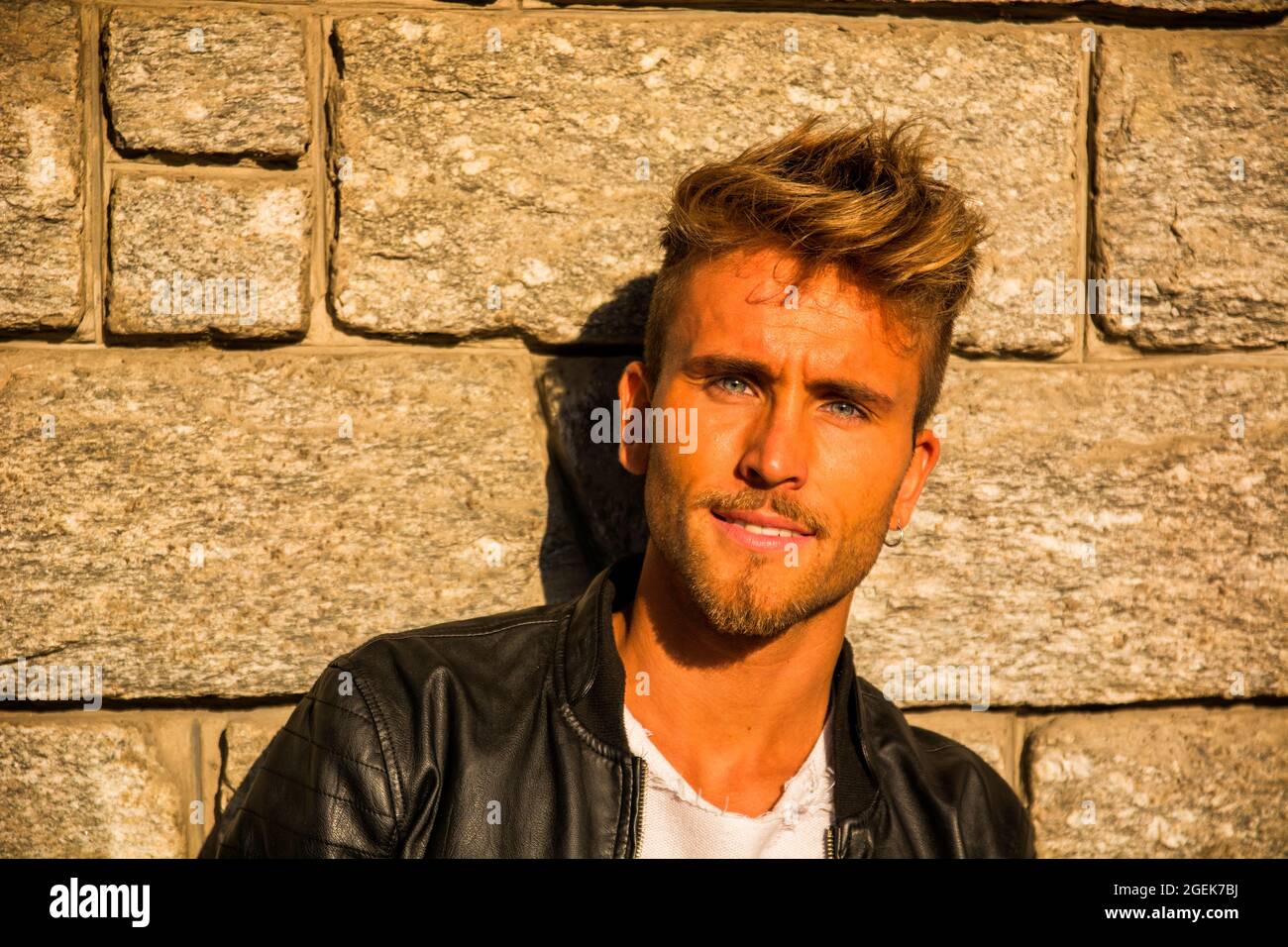 Portrait smiling man stone wall hi-res stock photography and images - Alamy