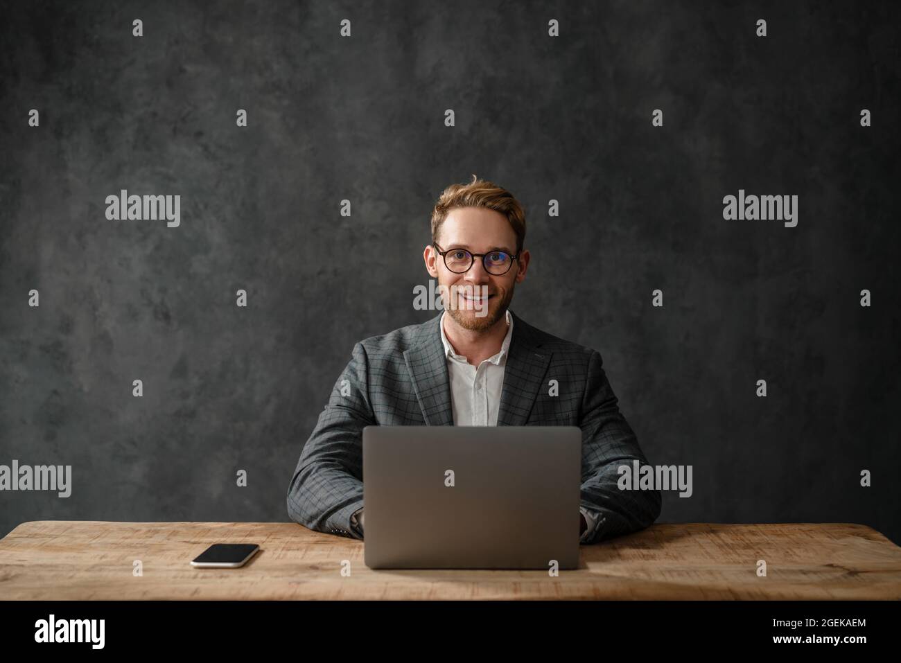 The smiling man in a jacket and shirt looking at the camera while ...