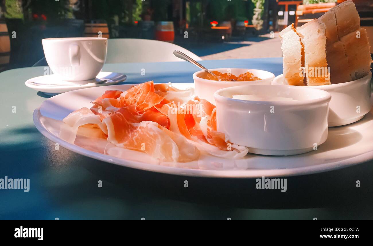 Breakfast outdoors in summer, ham, jam, butter and ham Stock Photo - Alamy
