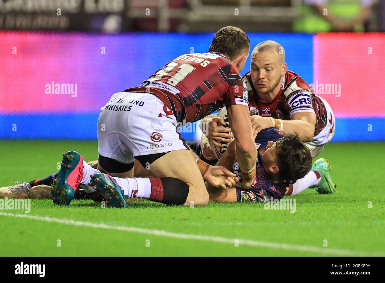 Wigan, UK. 20th Aug, 2021. Lachlan Coote (1) of St Helens is tackled by ...