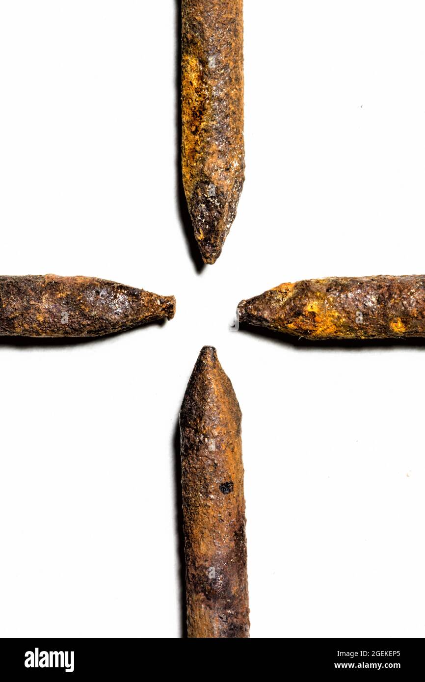 Four rusty nails forming cross shape on white background Stock Photo ...