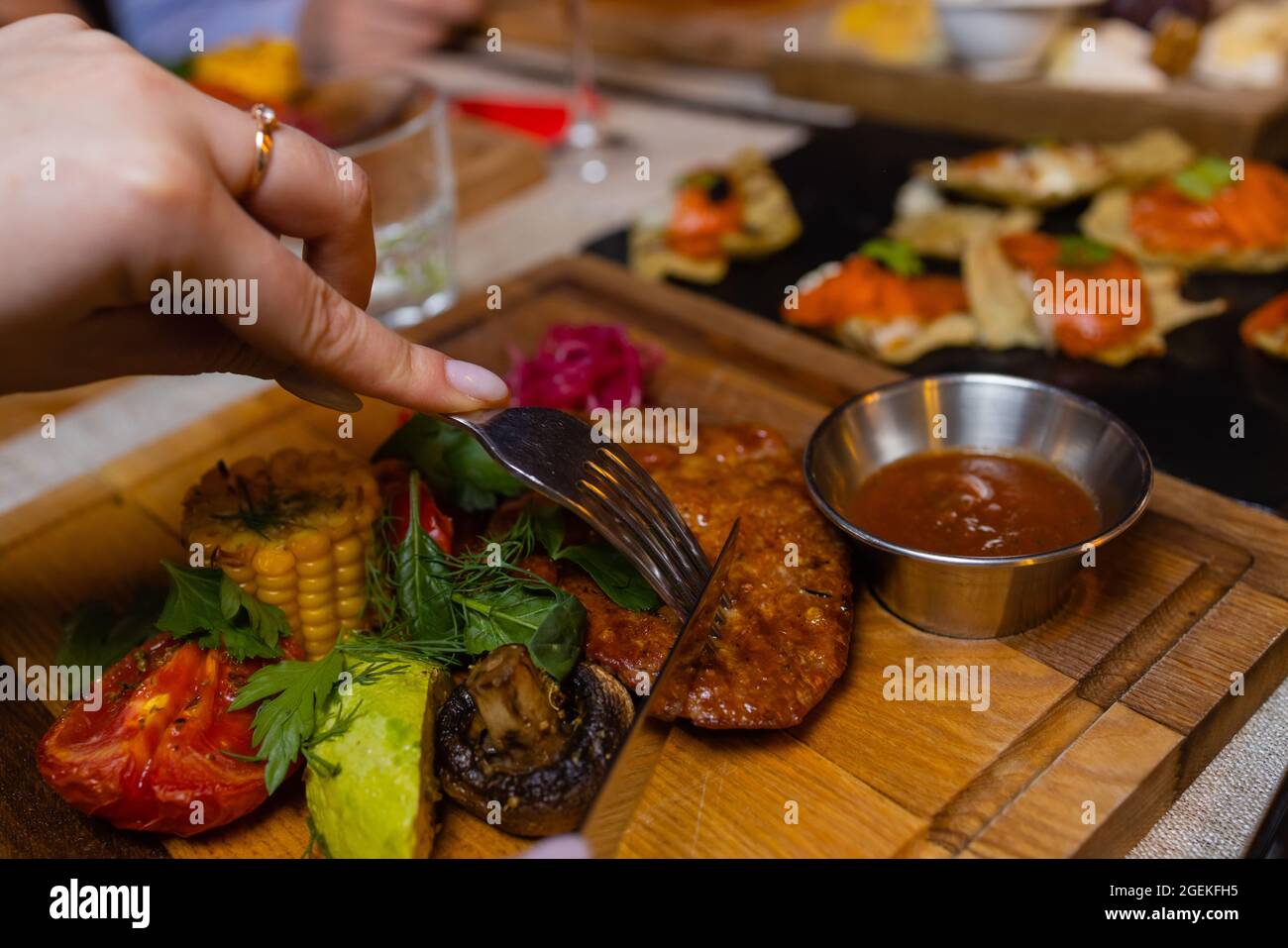 Young woman eating pork steak hi-res stock photography and images - Alamy