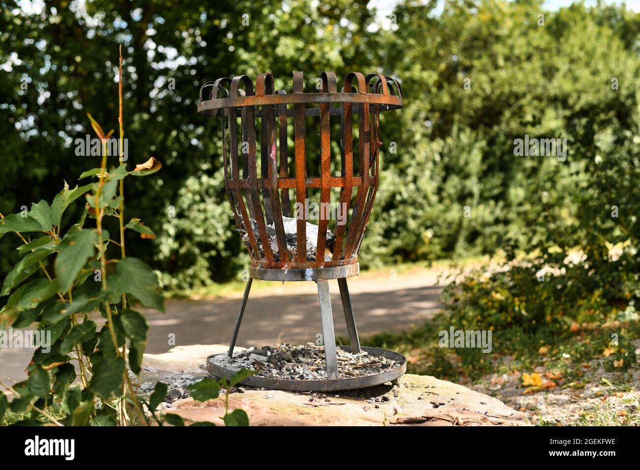 Old rusty metal fire brazier with old burned charcoal in forest Stock ...