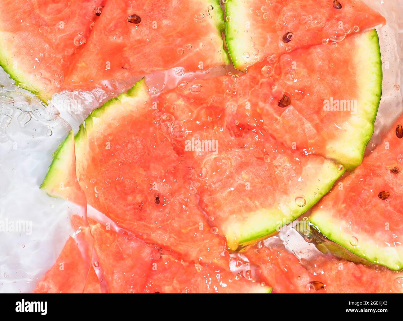 Melon close-up in liquid with bubbles. Slicec of red ripe melon in ...