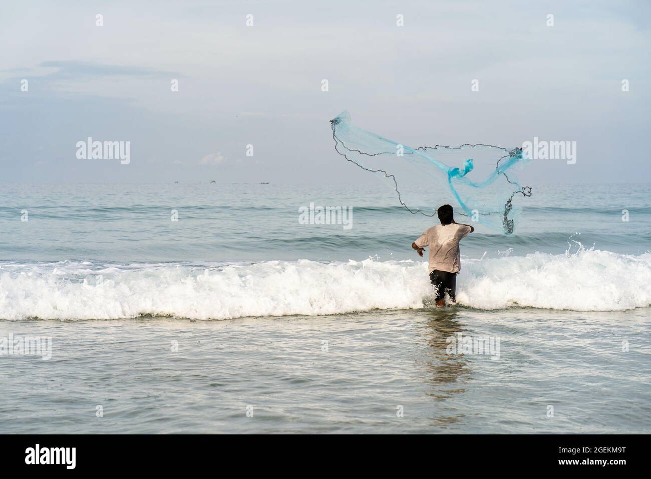 Back view of a male with a fishnet in the sea Stock Photo - Alamy