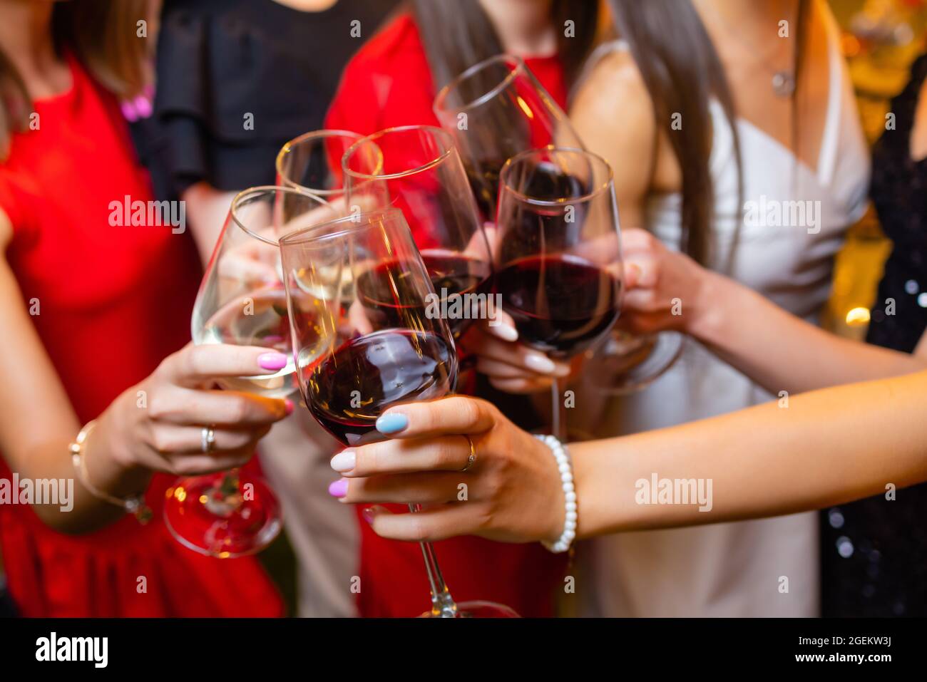 Clinking glasses with alcohol and toasting, party Stock Photo - Alamy