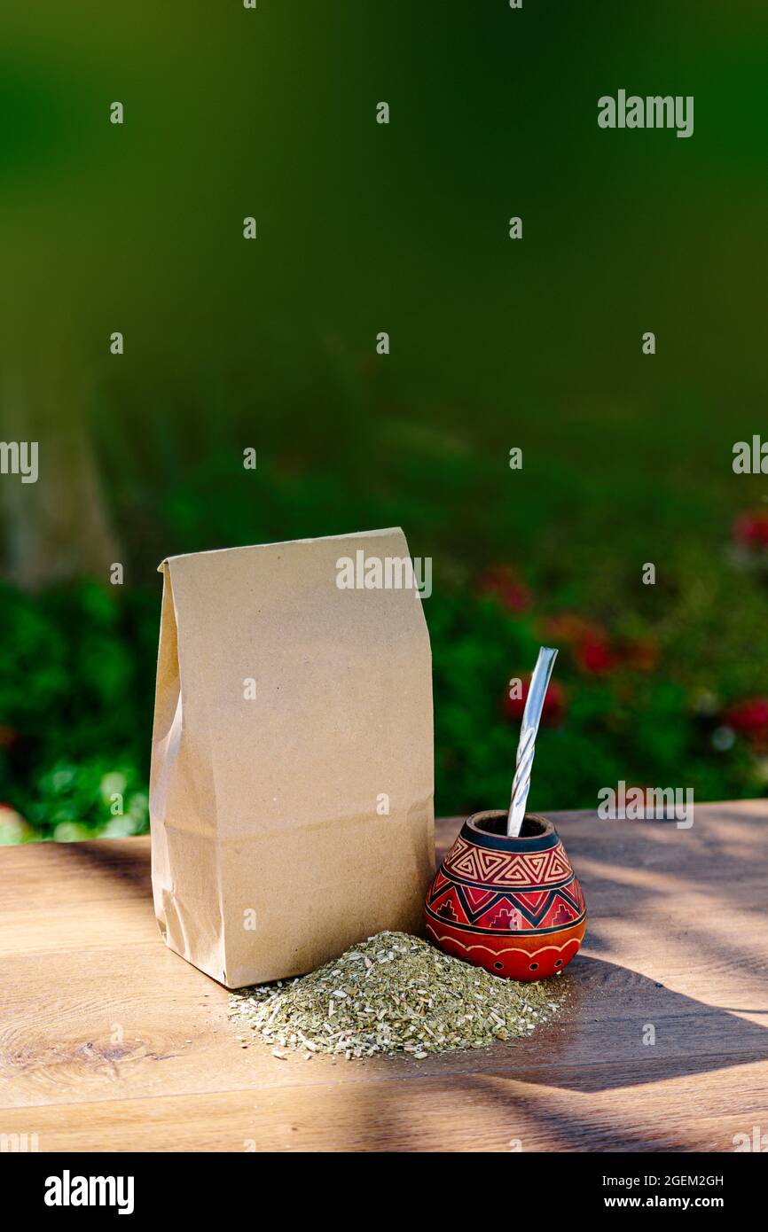 A rustic pack of brown paper with a traditional mate made of calabash ...