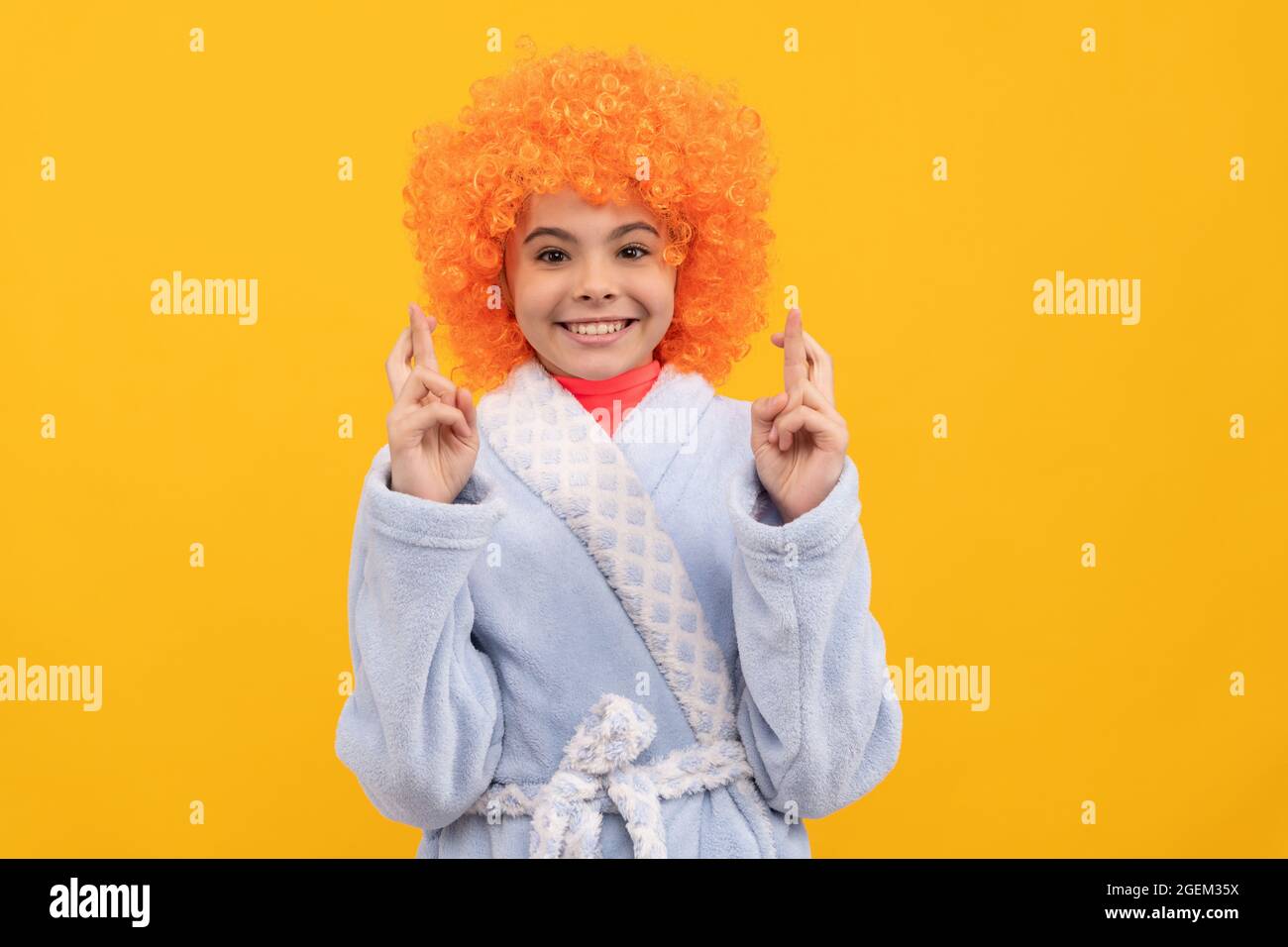 funny kid in curly clown wig. fancy child wear home bathrobe Stock ...