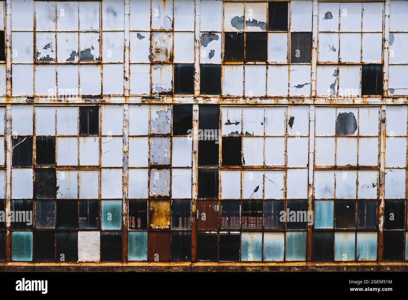 Grungy old window in abandoned factory with broken glass, boards and ...