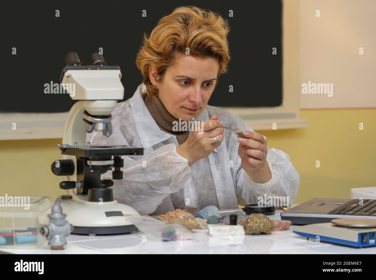 Female geologist researcher analysing a rock at her workplace Stock ...
